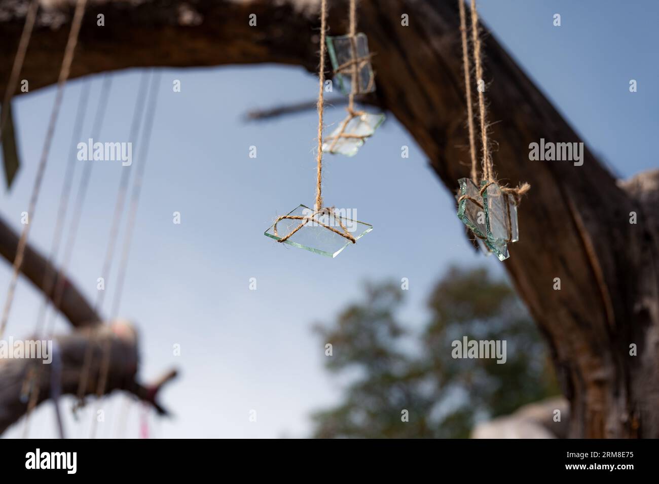 Group of pieces of the glass on the strings with the sky as background ...