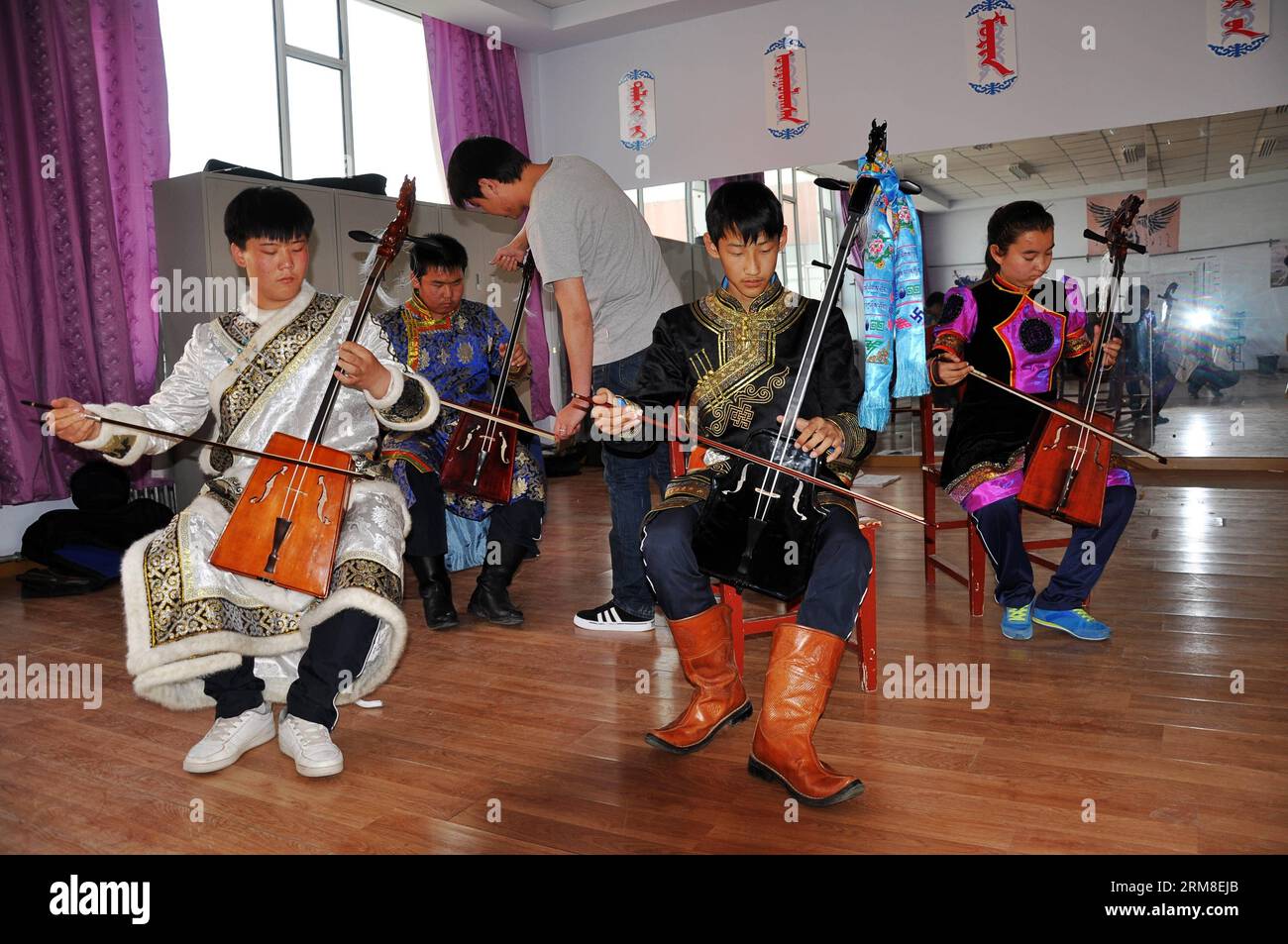 BAYAN NUR, Students learn to play Matouqin, a horse-head musical ...