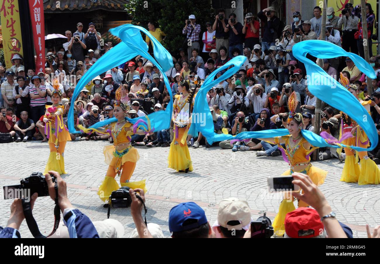 Actors perform folk dance in celebration of the birthday of Chinese god ...