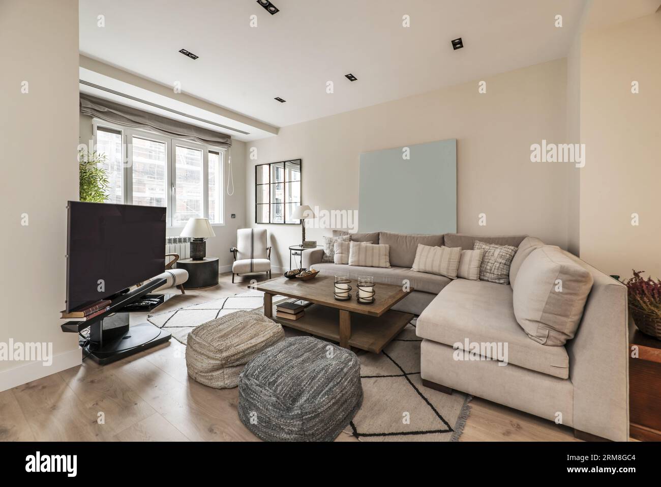 A living room with a rest area and movie viewing with a large gray ...