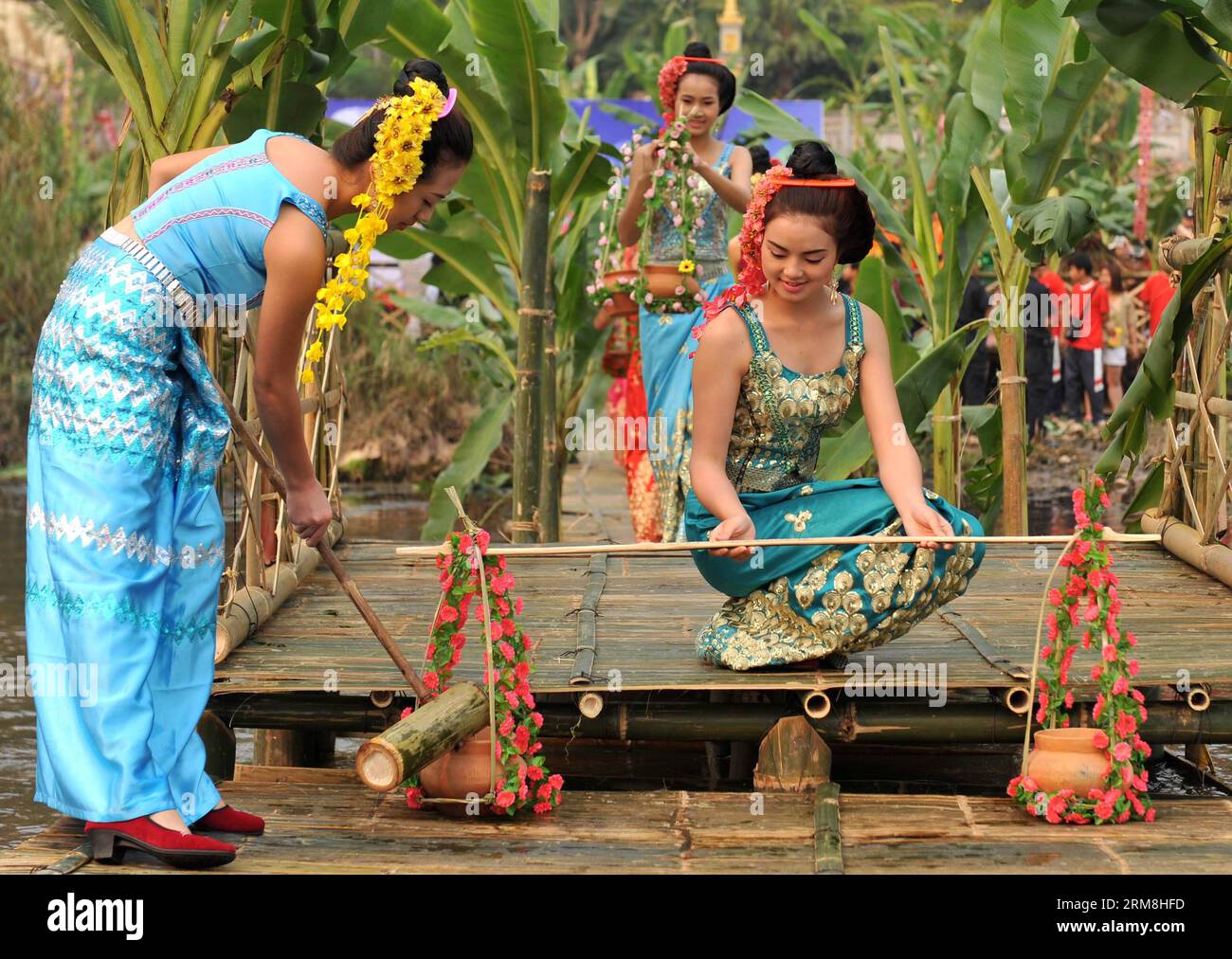 Girls of the Dai ethnic group fetch water during the Water-splashing ...