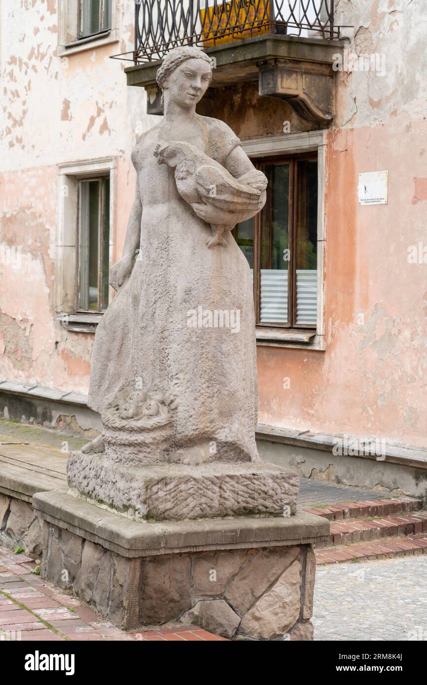 Monument to a girl holding a chicken in her arms. Poultry farming in ...