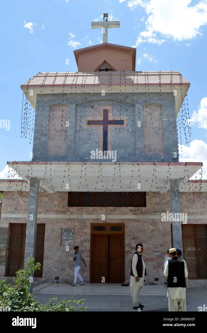 Pakistani Christians stand outside a church after a Good Friday service ...