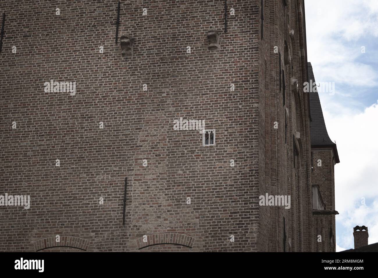 The smallest window in Brugge in the wall of the Gruuthusemuseum Stock ...