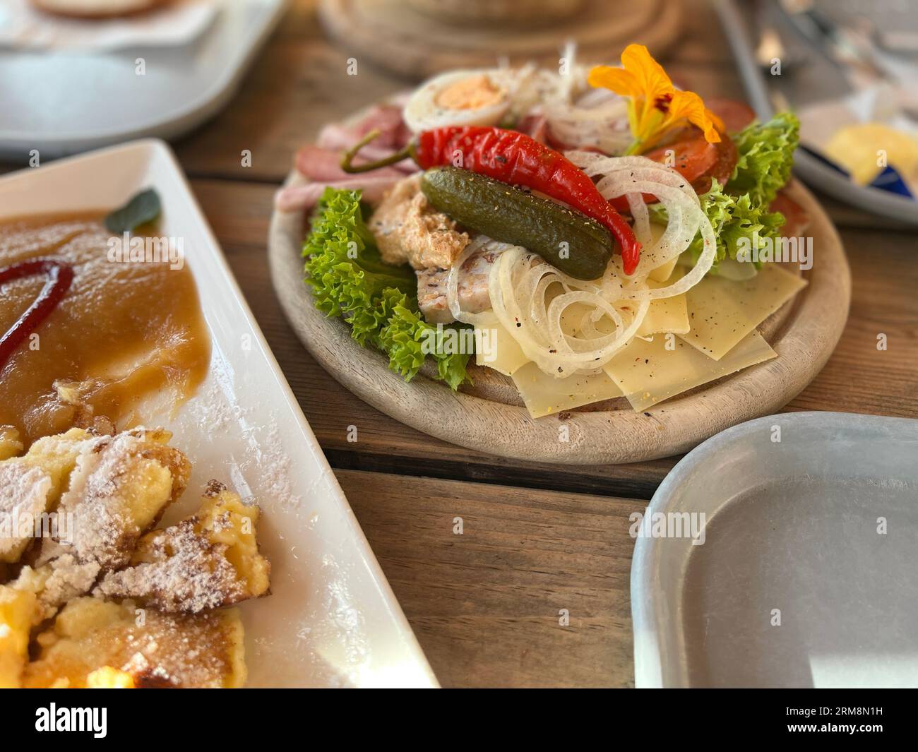 Delicious breakfast options with rustic platter of cold cuts, cheese ...