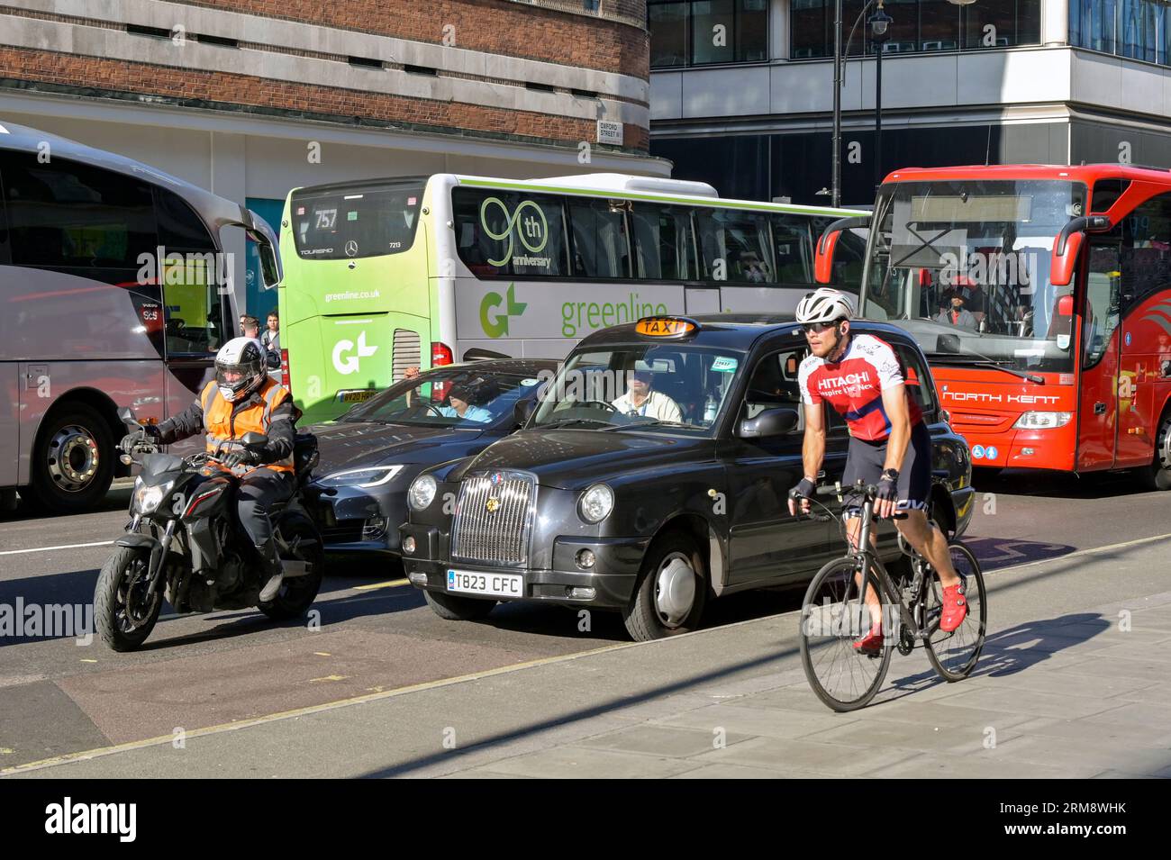 London, England, UK - 22 August 2023: Cyclist riding on the pavement in ...