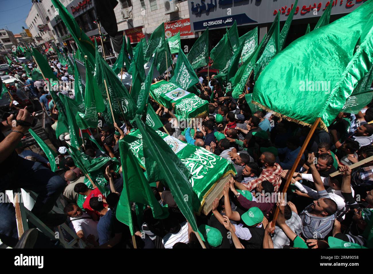 Palestinians attend the funeral of two Hamas members who were killed in ...
