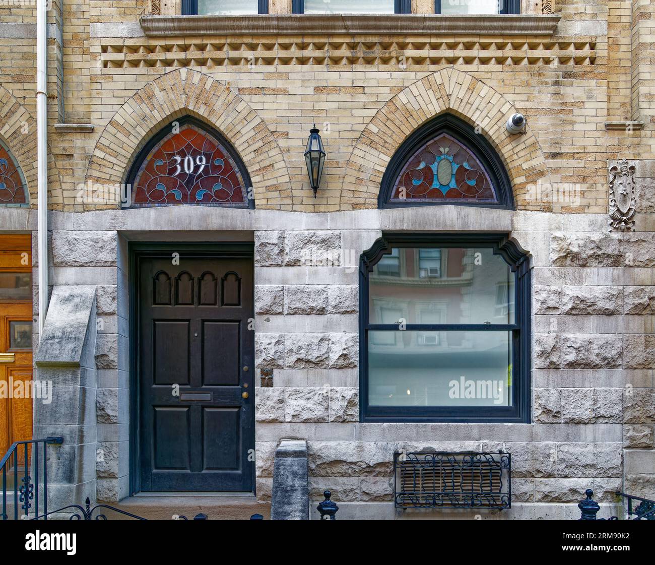 Upper West Side: Gothic-arched stained glass fan lights set in brick ...