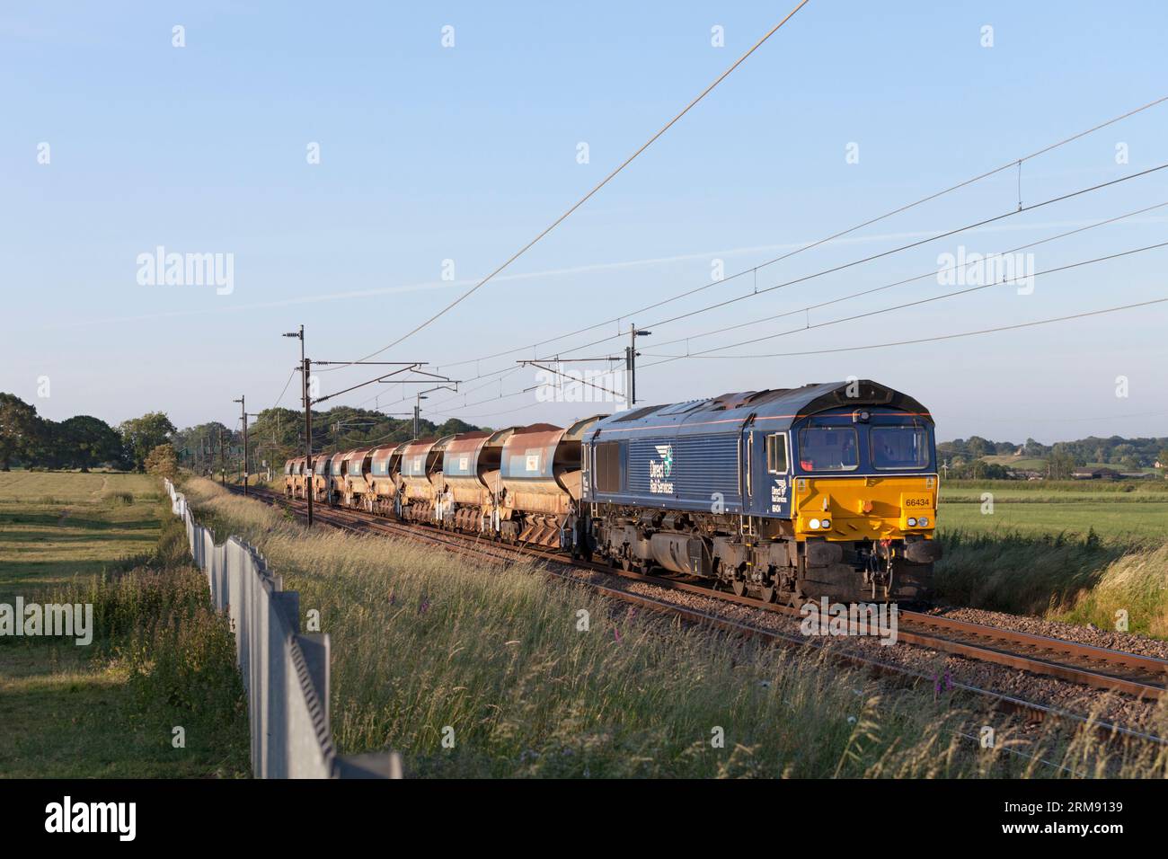 DRS class 66 locomotive hauling a freight train carrying materials for ...
