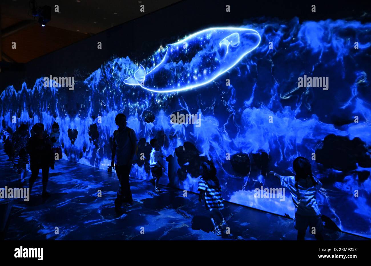 Tianjin. 26th Aug, 2023. People interacts with virtual marine organisms ...