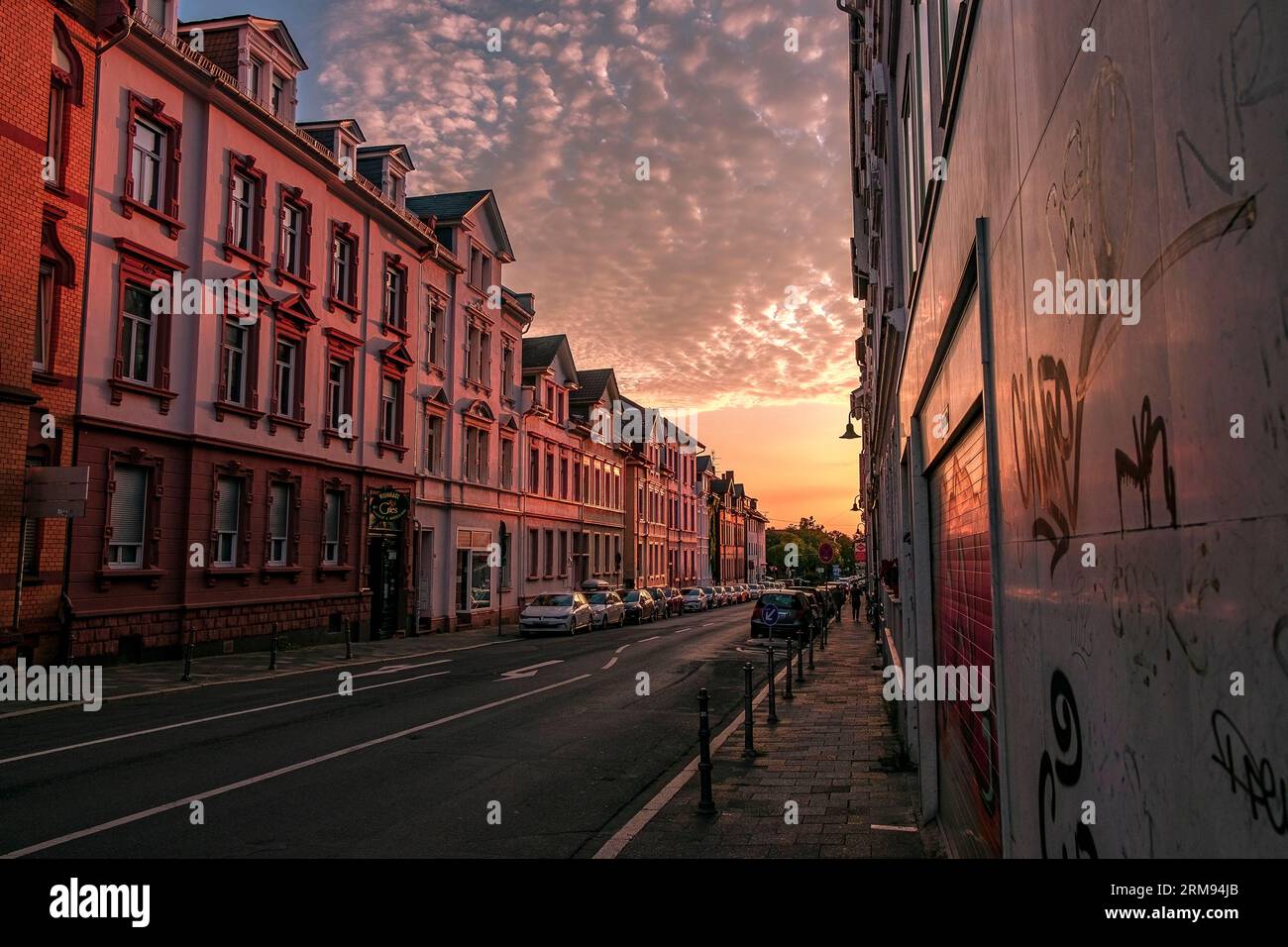 sunset on the street in Germany with warm color clouds and nearly empty ...