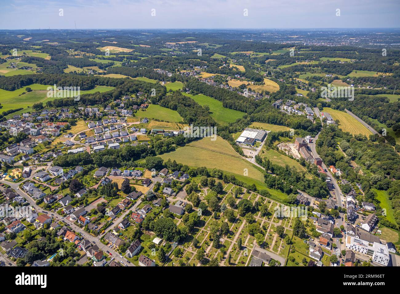 Aerial view, meadows and fields in hilly landscape, new residential ...