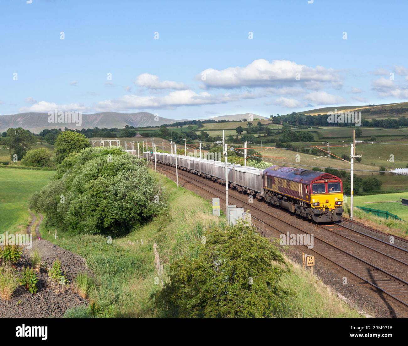 DB Cargo class 66 locomotive in EWS livery passing Docker (north of ...