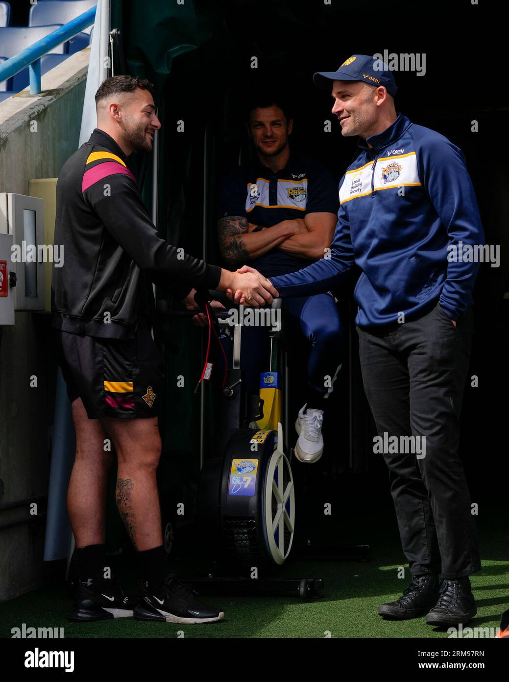Rohan Smith Head Coach of Leeds Rhinos greets Jake Connor #1 of ...