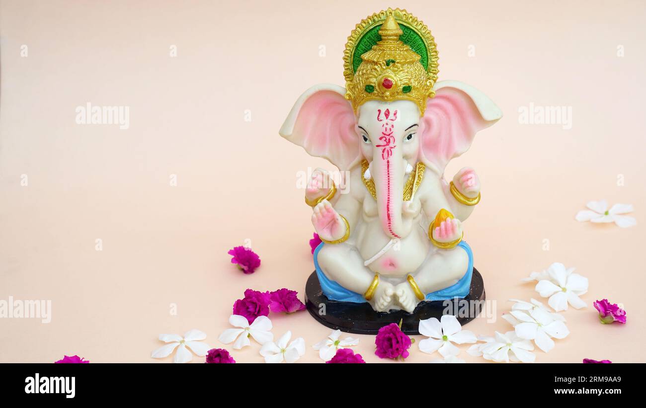 Hindu God Ganesha sclupture over pink background. Celebrate Lord ...