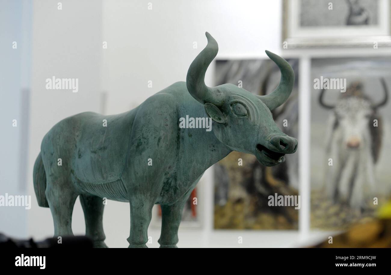 Photo taken on May 18, 2014 shows a bronze sculpture of yak displayed ...