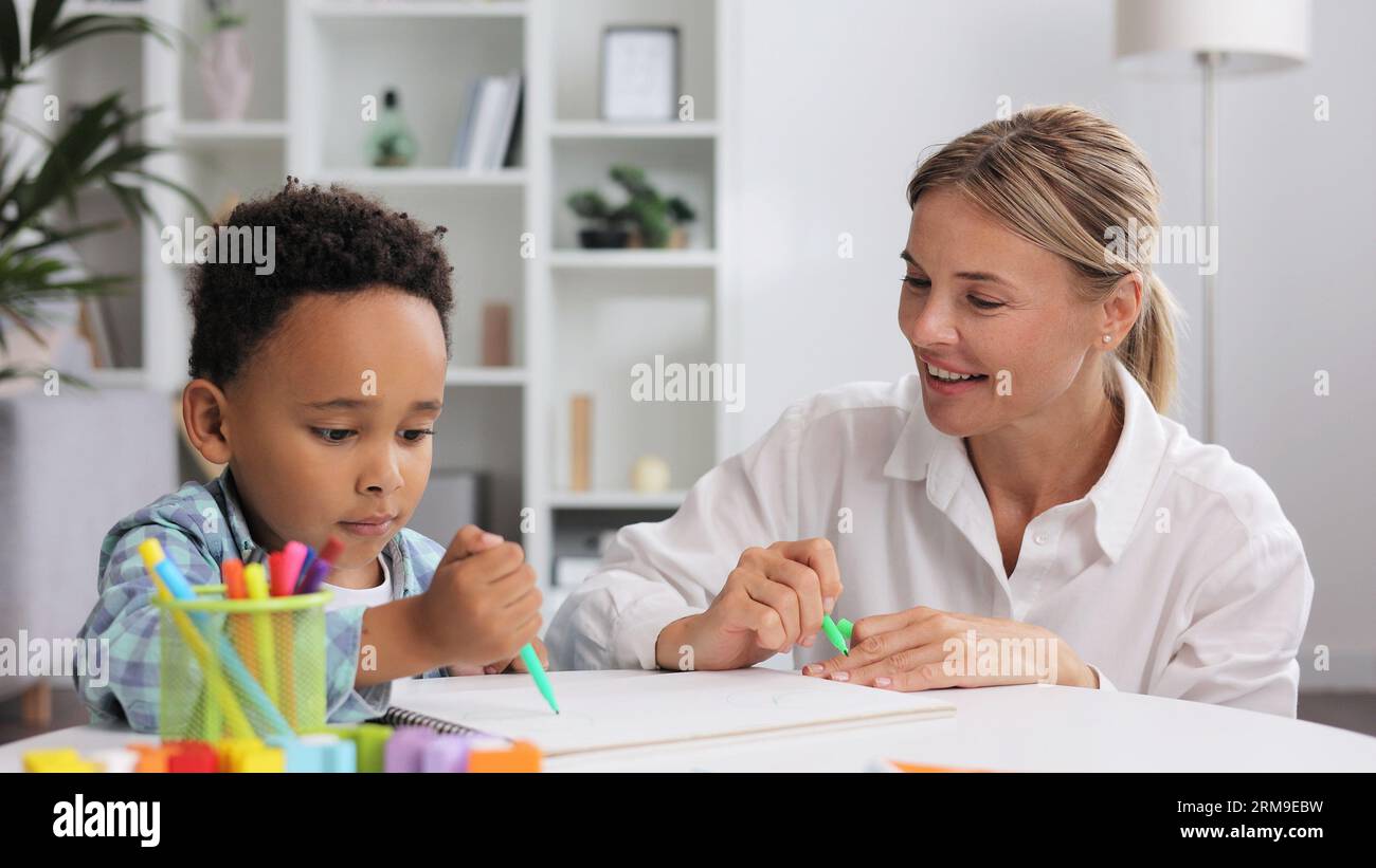 Adorable little african american boy with curly hair having fun at ...