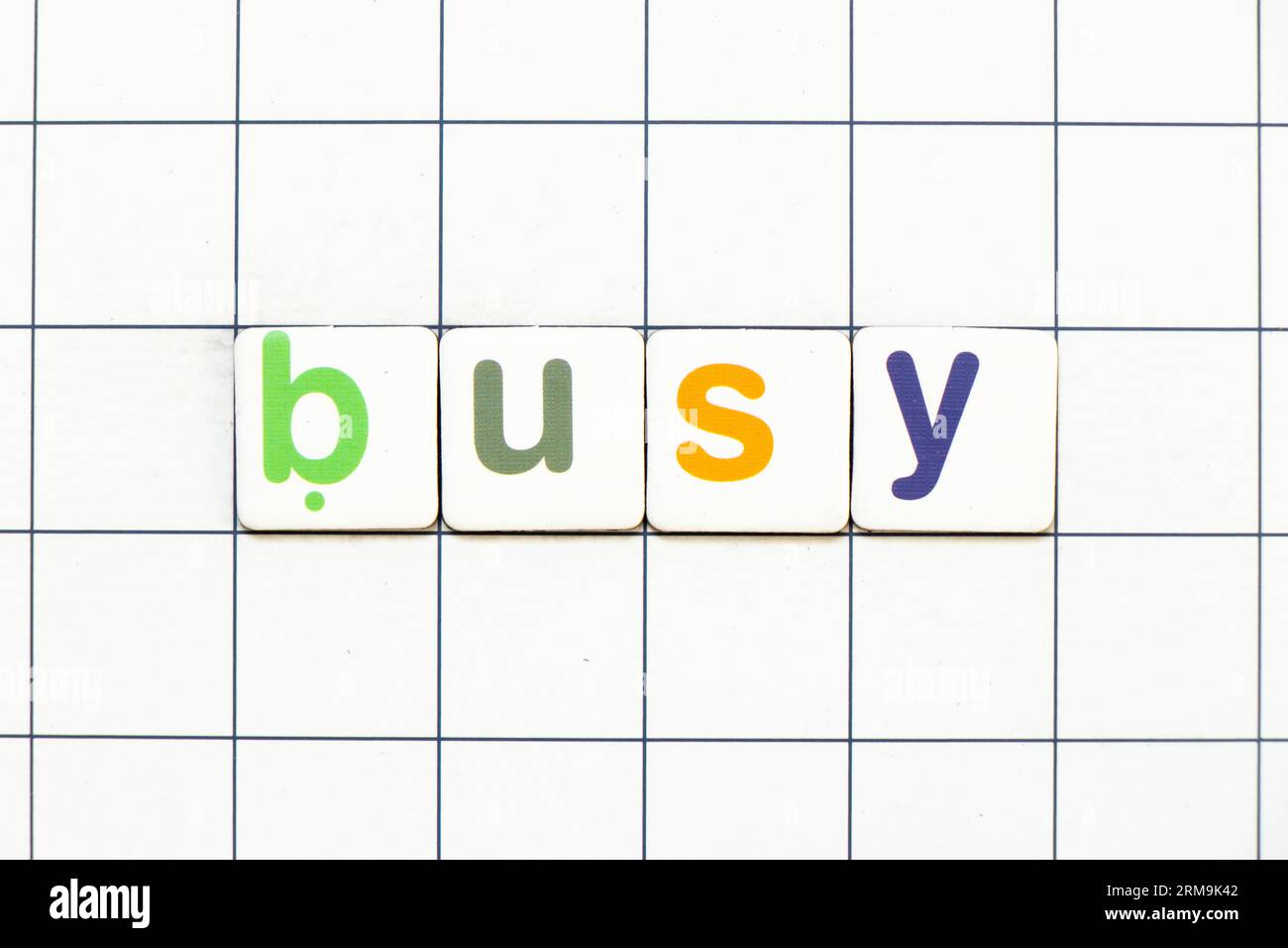 Colorful tile letter in word busy on white grid background Stock Photo ...