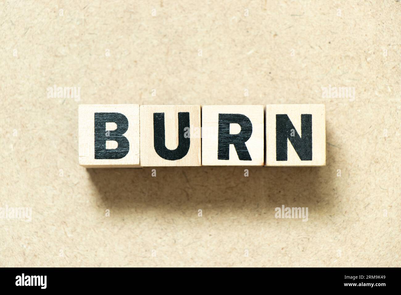 Alphabet letter block in word burn on wood background Stock Photo - Alamy