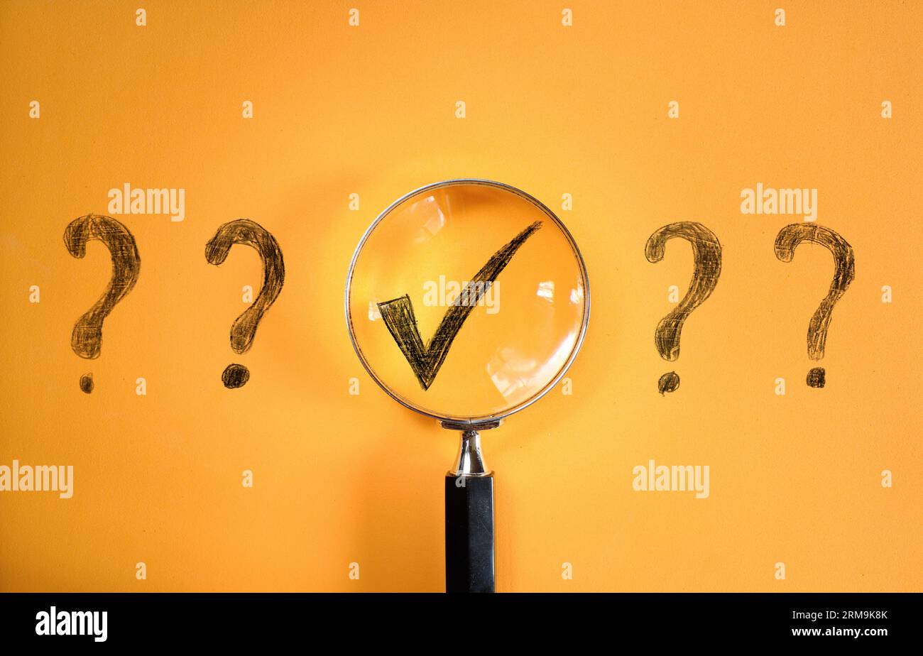 Magnifier enlarging the correct choice or check mark on yellow ...