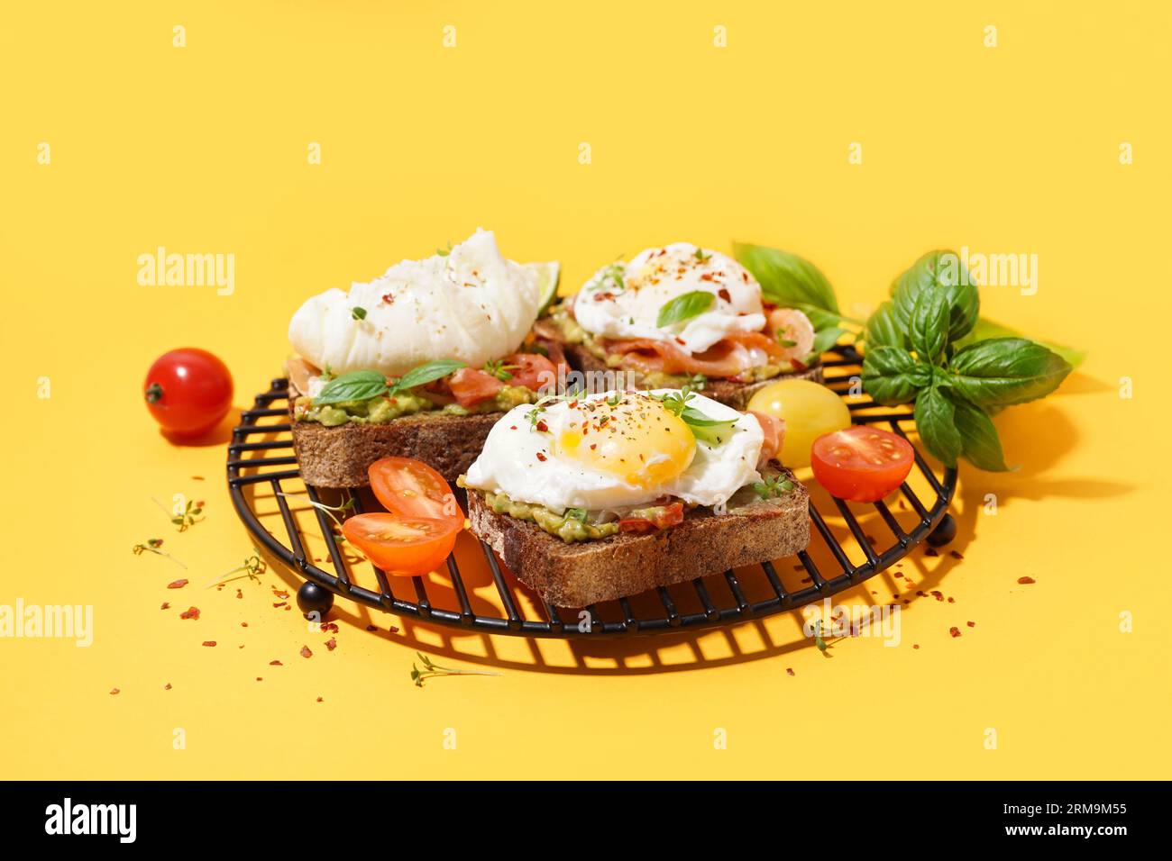 Grid of tasty sandwiches with egg on yellow background Stock Photo - Alamy