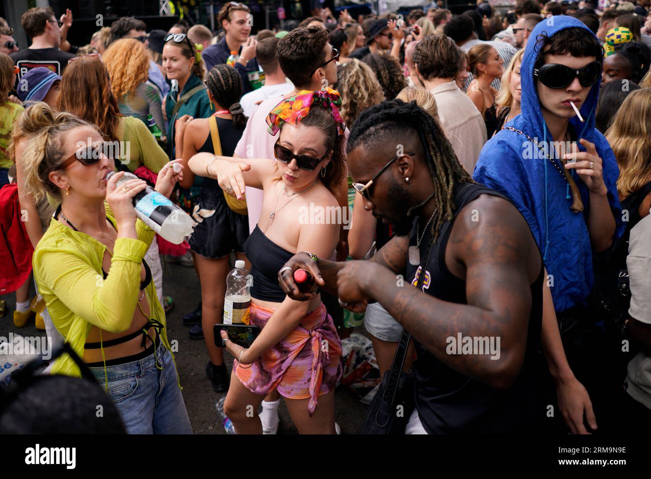 Revellers dance to the music as they attend the first day of the ...