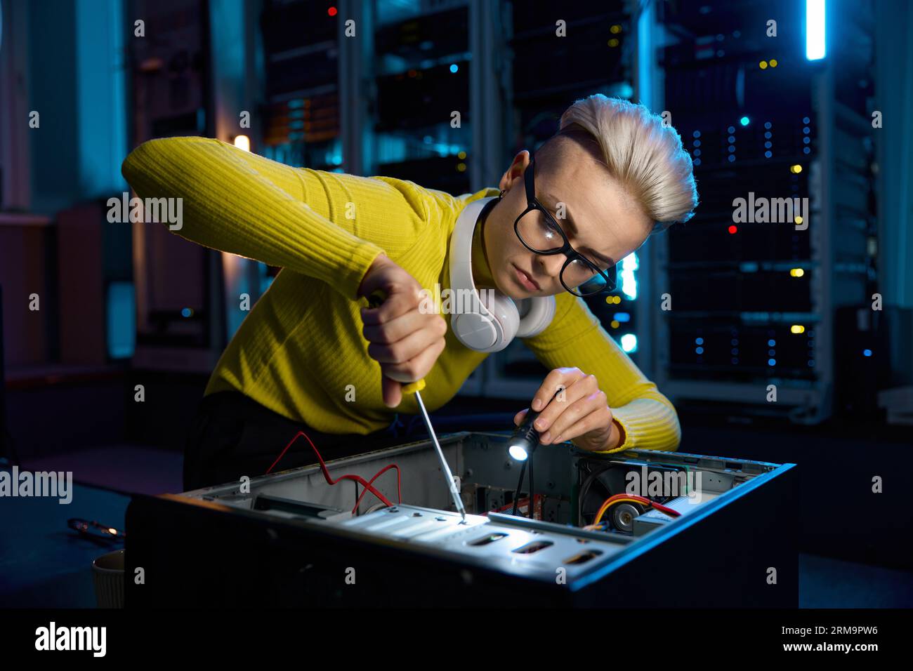 Young IT woman repairing computer system unit using screwdriver Stock ...