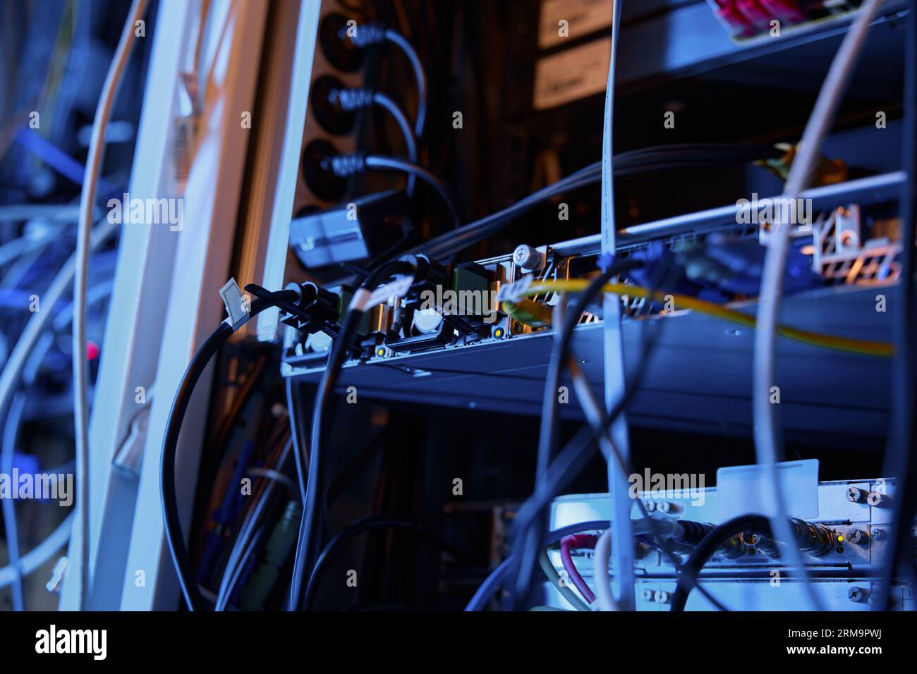 Closeup wires and cables in dark server room Stock Photo - Alamy