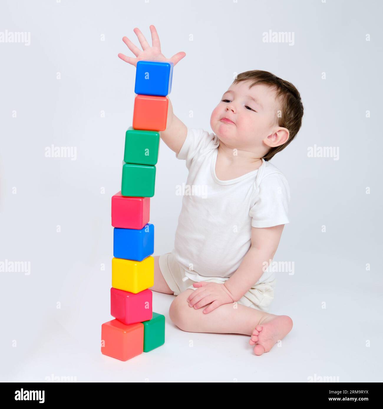 Happy baby play educational toys on studio white background. Portrait ...