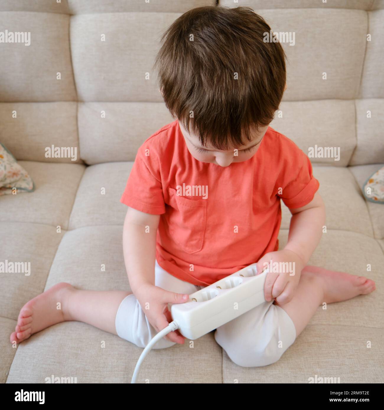 The child's playtime with an electrical cord at home is a hazardous ...