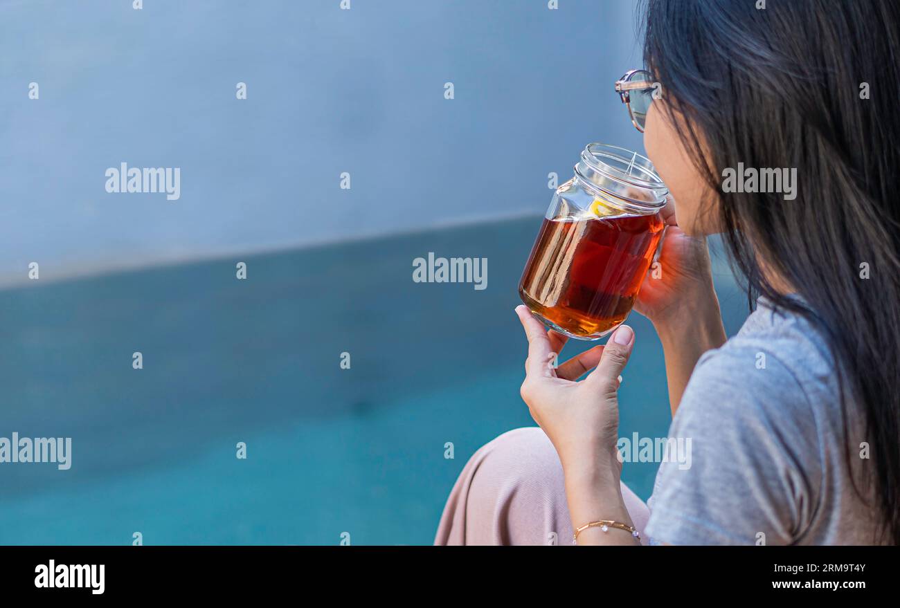 holding a cup of a hot tea on swimming pool Stock Photo - Alamy