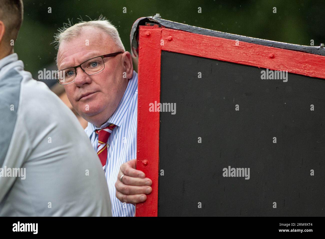 Football manager Steve Evans peering from dugout whilst in charge of ...