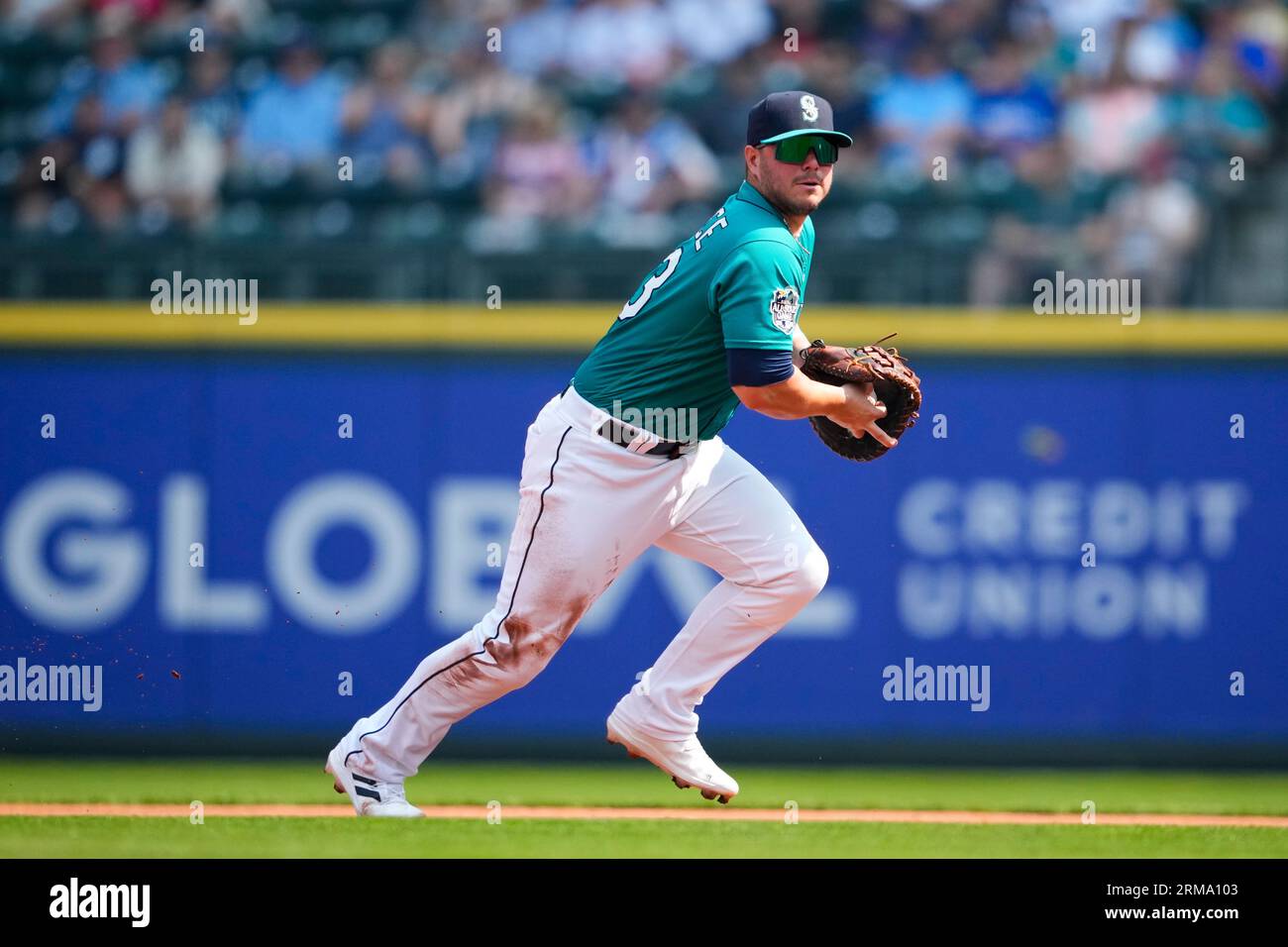 Seattle Mariners first baseman Ty France fields a ball in a baseball ...