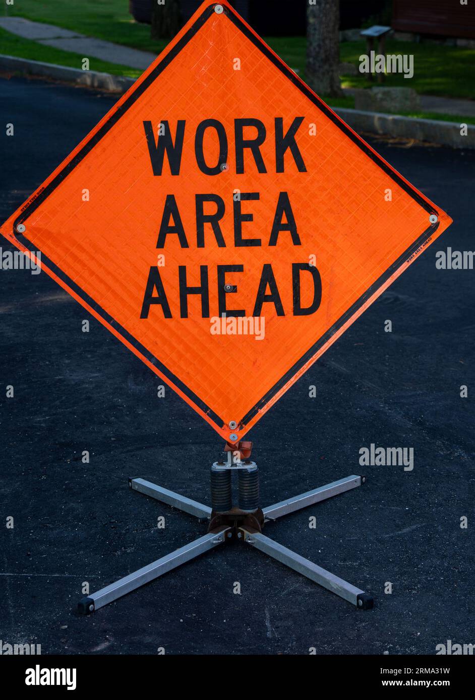 work area ahead neon orange safety sign Stock Photo - Alamy