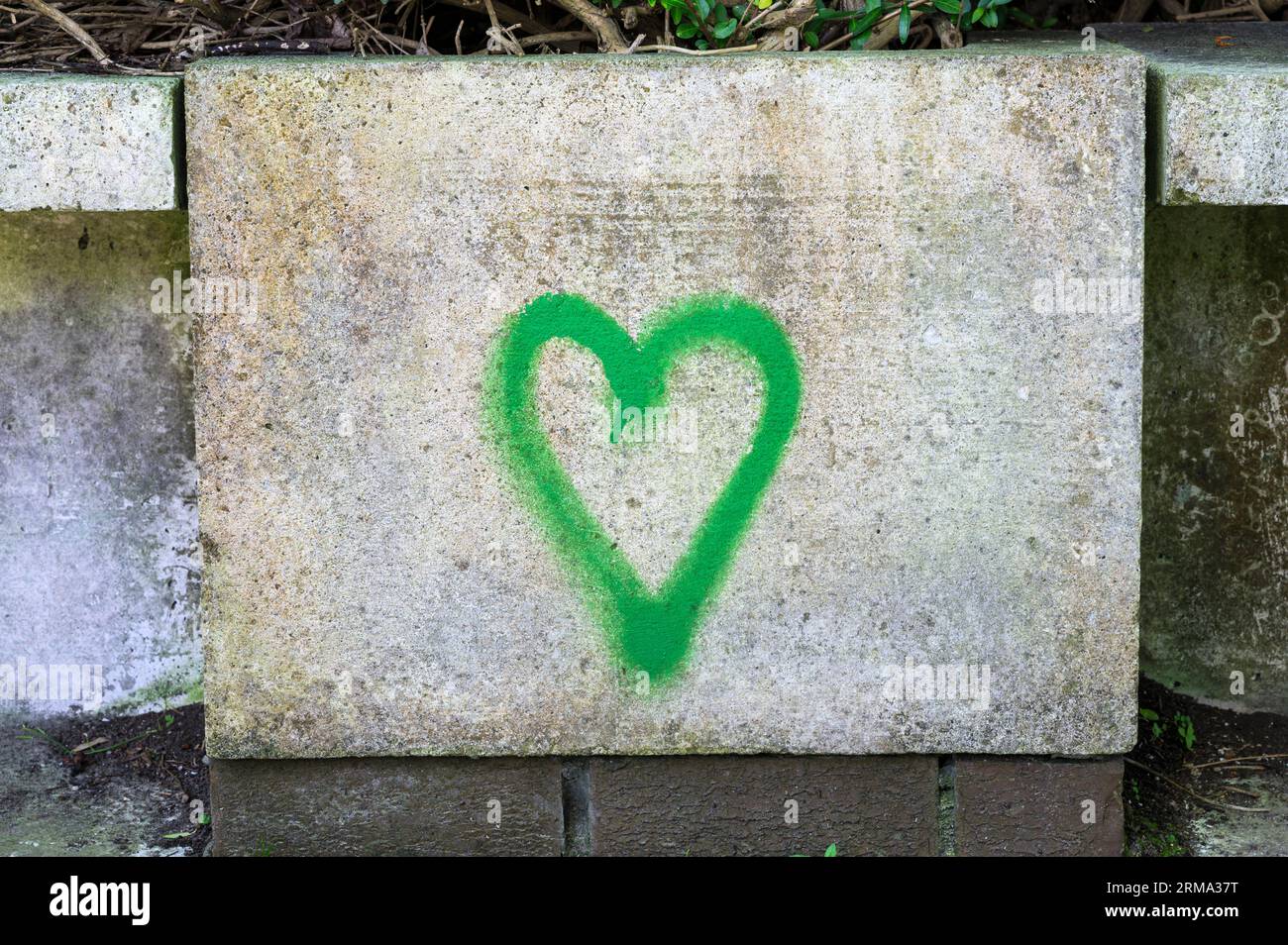 Green heart shape spray painted on concrete Stock Photo - Alamy