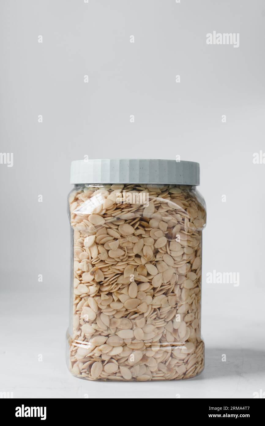 nigerian egusi seeds in a glass jar, shelled melon seeds in a ...