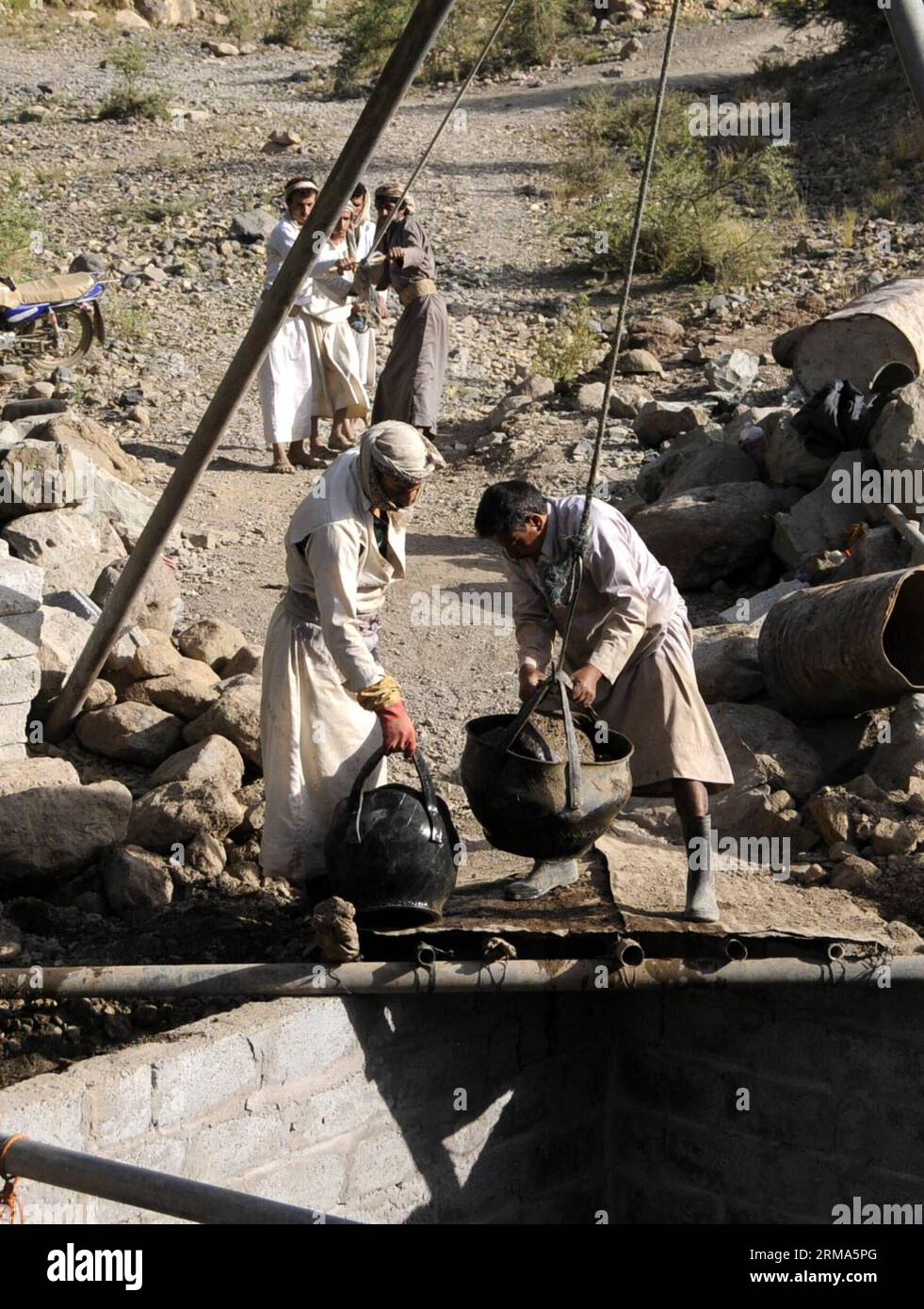 Yemeni farmers are seen digging a well to find water as less rainfall ...
