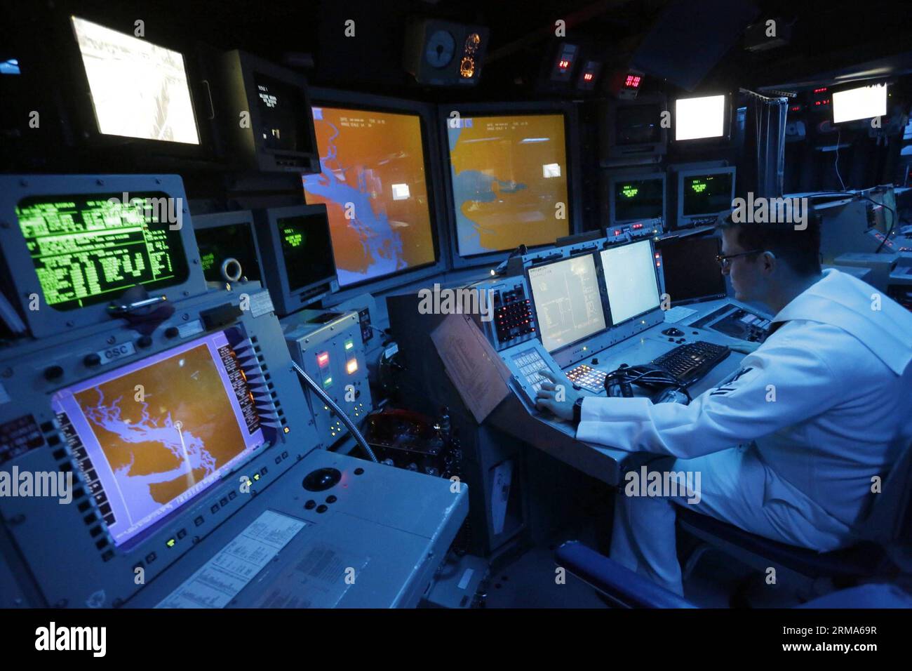 Crew member works inside the command information centre of the USS ...