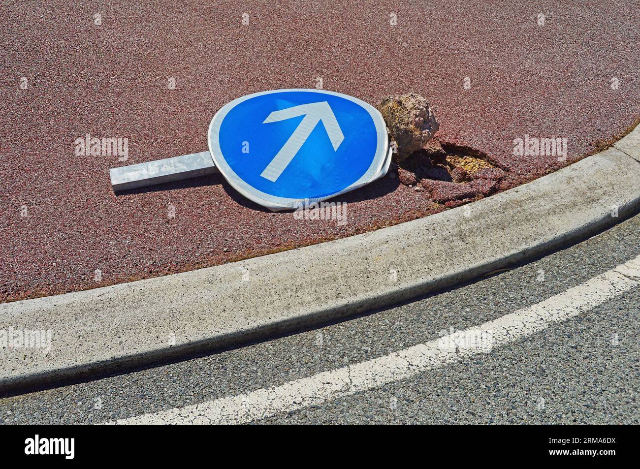 A broken road sign on a roundabout Stock Photo - Alamy