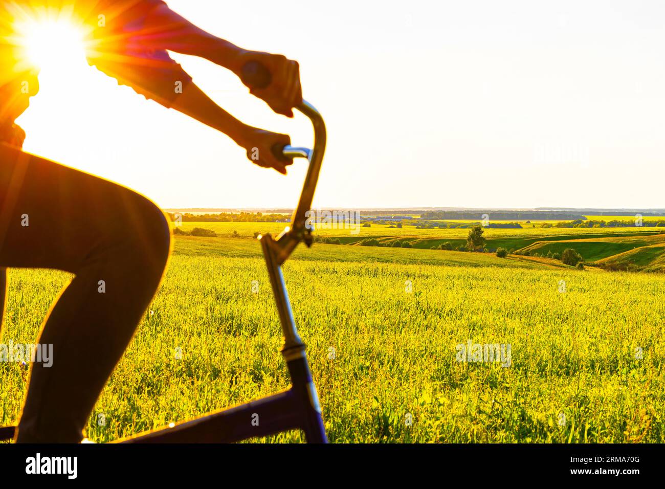 Woman riding bike through field hi-res stock photography and images - Alamy