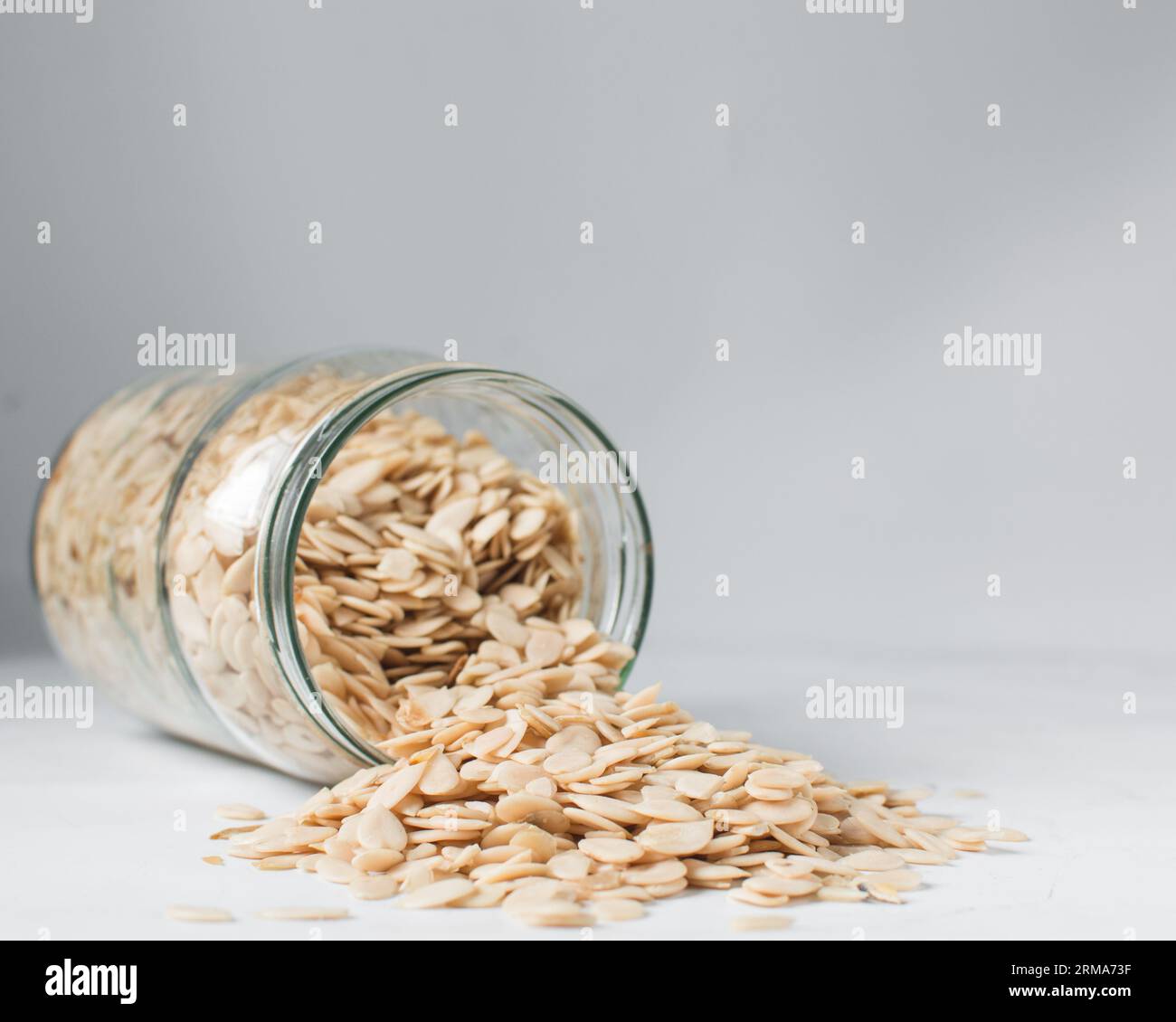 nigerian egusi seeds in a glass jar, shelled melon seeds in a ...