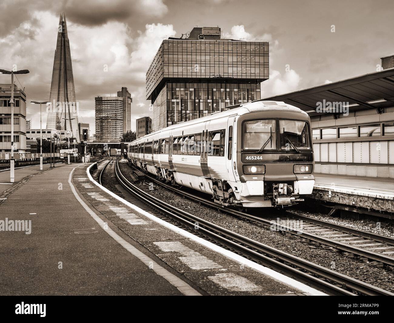 Train pulling into the platform at London Waterloo Train Station in a Sepia monotone Stock Photo ...