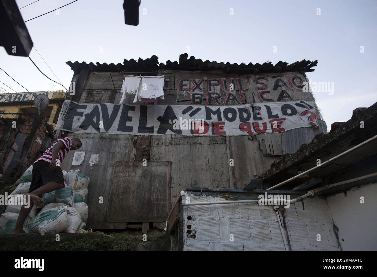 A man walks past a building in Favela Santa Marta, Rio de Janeiro ...