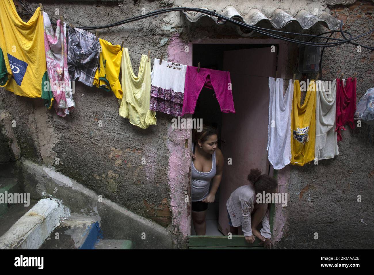 Two women are seen inside a house at Favela Santa Marta, Rio de Janeiro ...