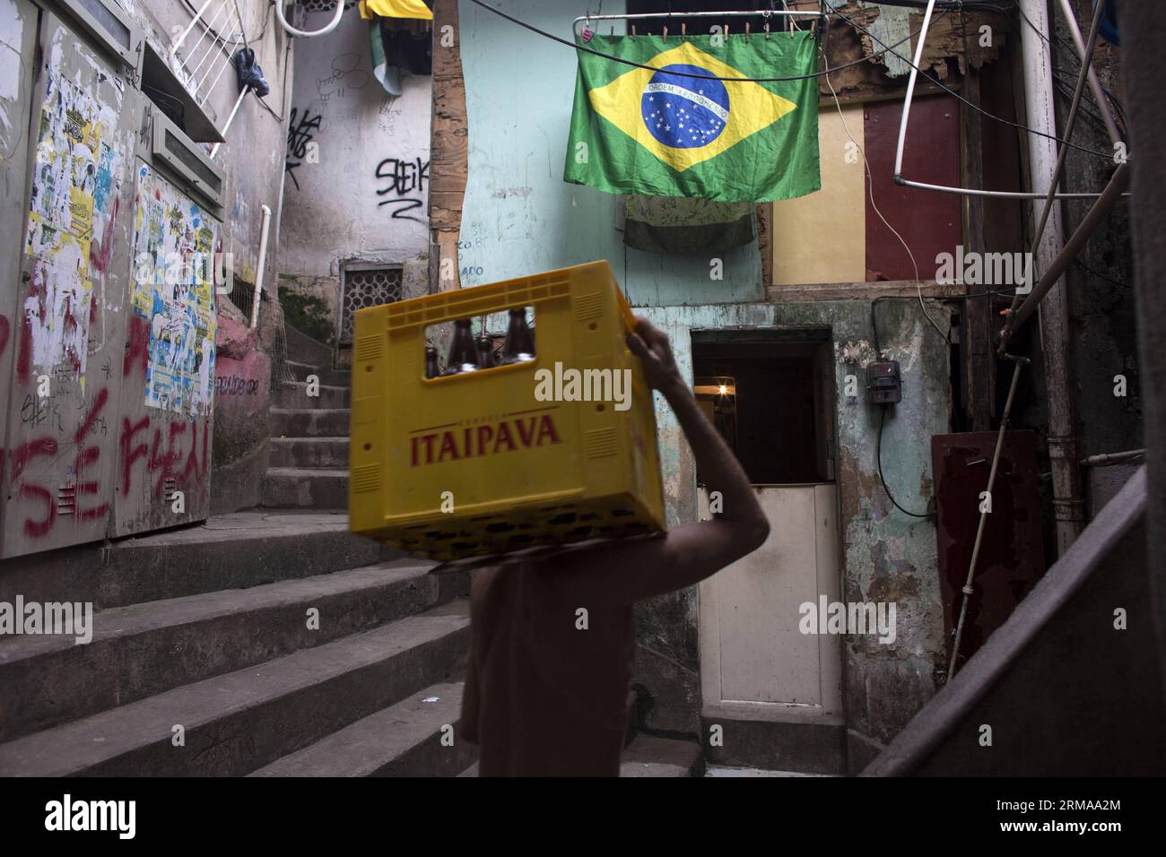 A man carries a basket of beer bottles in Favela Santa Marta, Rio de ...