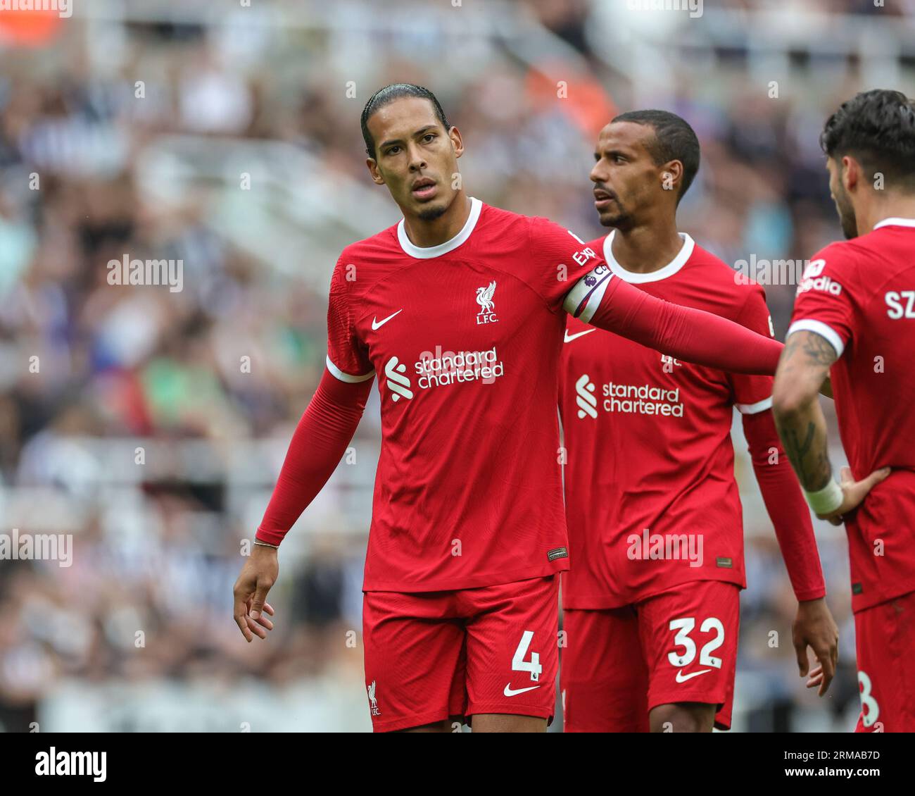Virgil van Dijk #4 of Liverpool gives Dominik Szoboszlai #8 of ...
