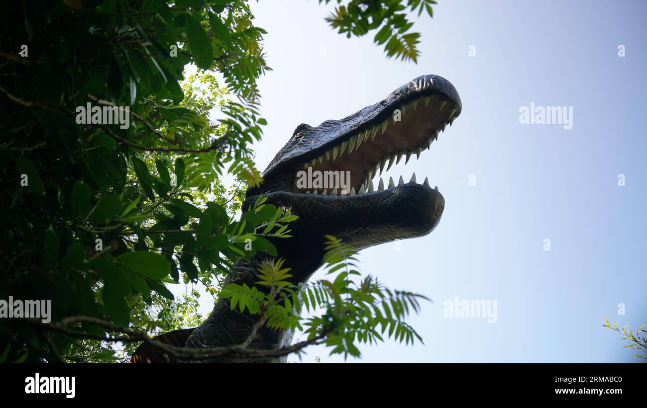 dinosaur walking in the forest. A hunting dinosaur with its mouth open ...