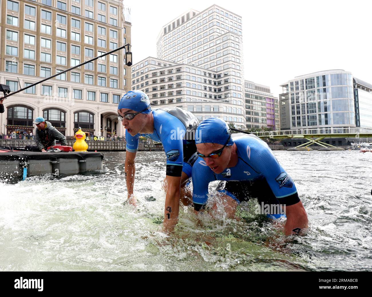Alex Yee (left) and Jonathan Brownlee emerge from water as they compete ...