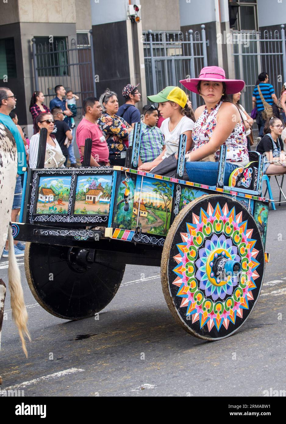 Woman and young girl riding in a beautifully hand painted ox cart in ...