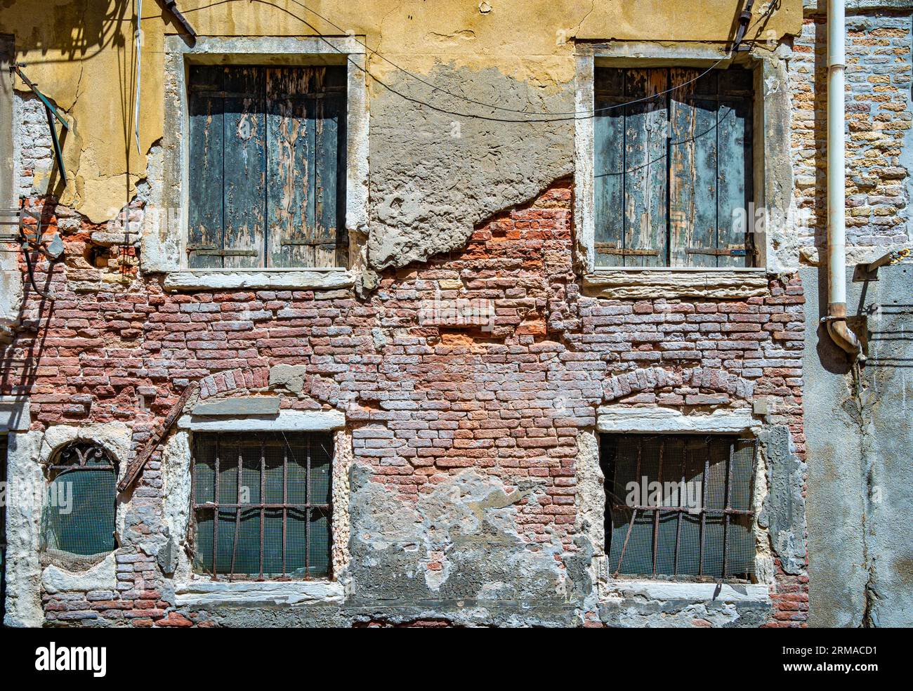 Old medieval worn out brick wall building in Venice, Italy Stock Photo ...